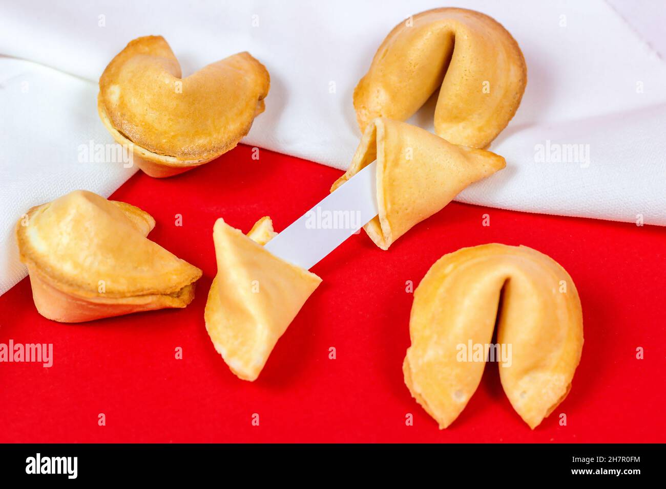 Fresh baked yellow Chinese fortune cookies with white blank note inside ...