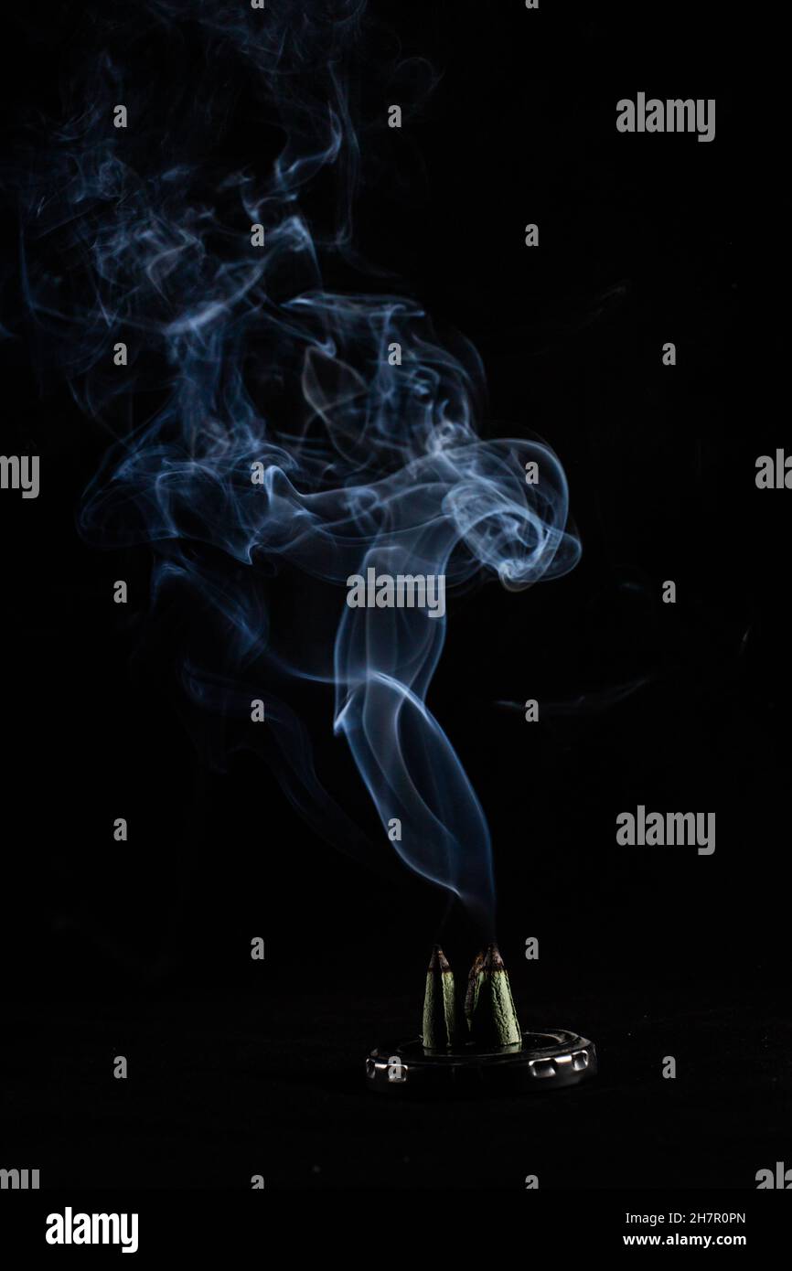 Smoke curves on a dark black background Stock Photo - Alamy