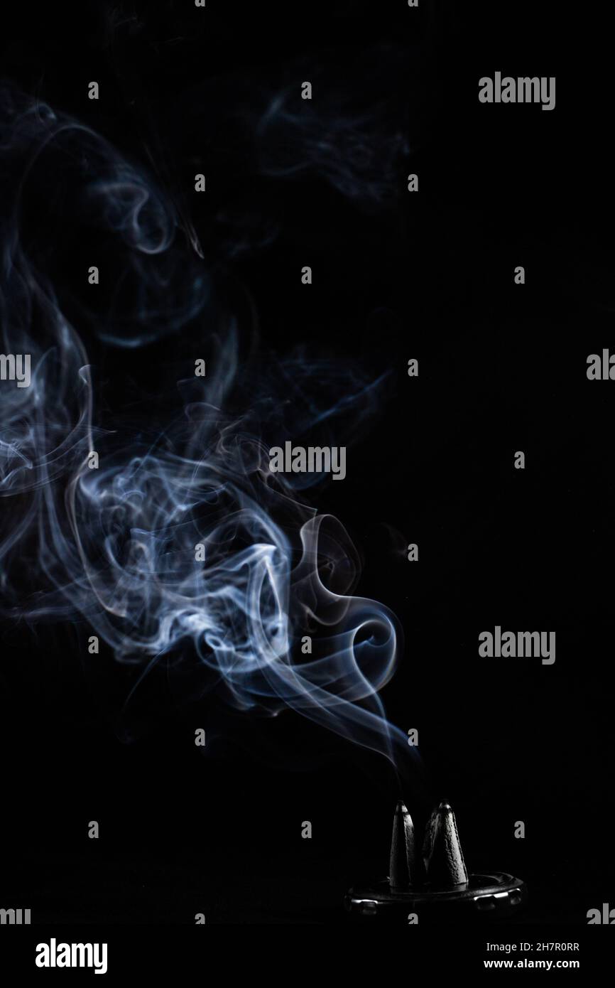 Smoke curves on a dark black background Stock Photo - Alamy