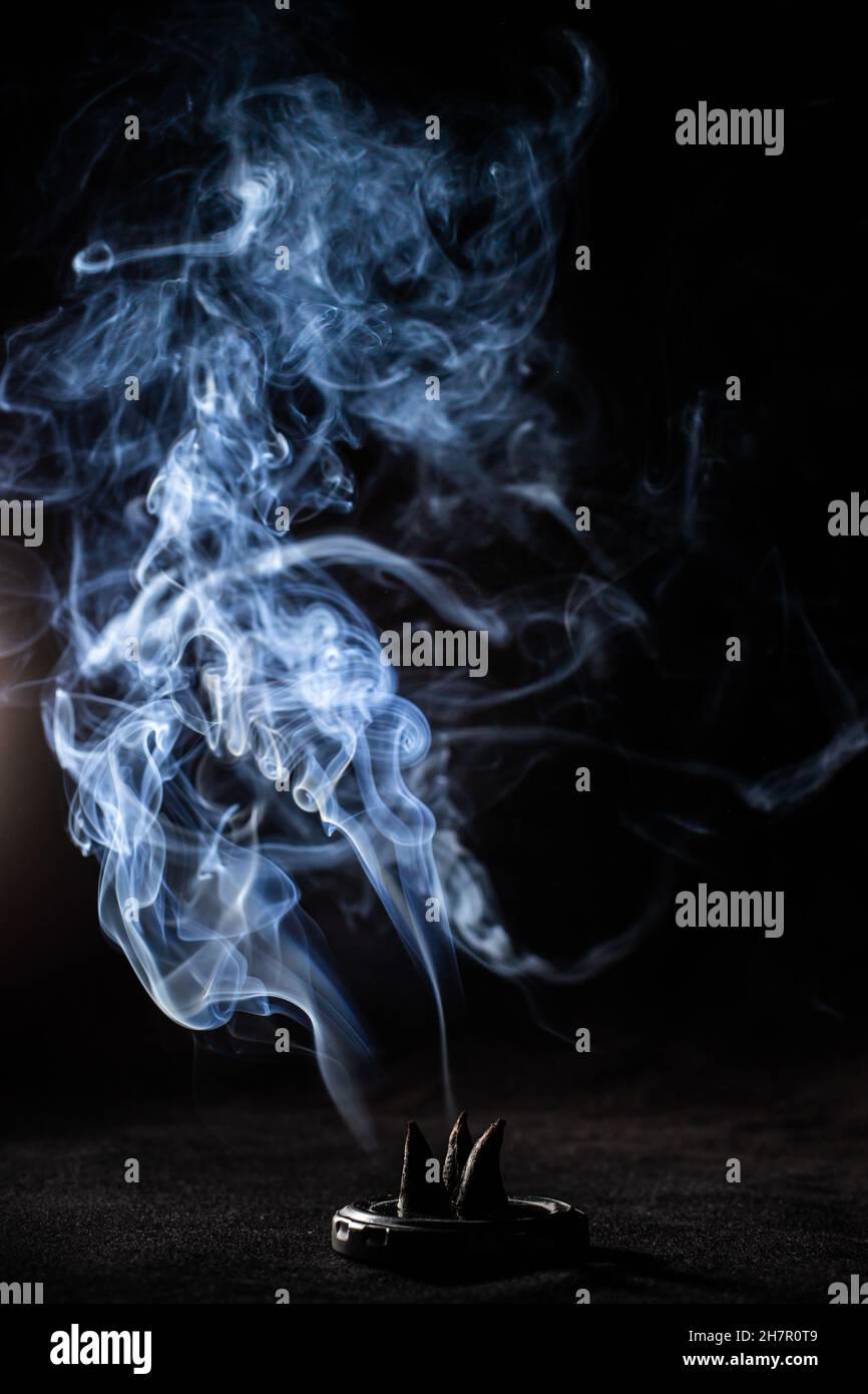 Smoke curves on a dark black background Stock Photo - Alamy