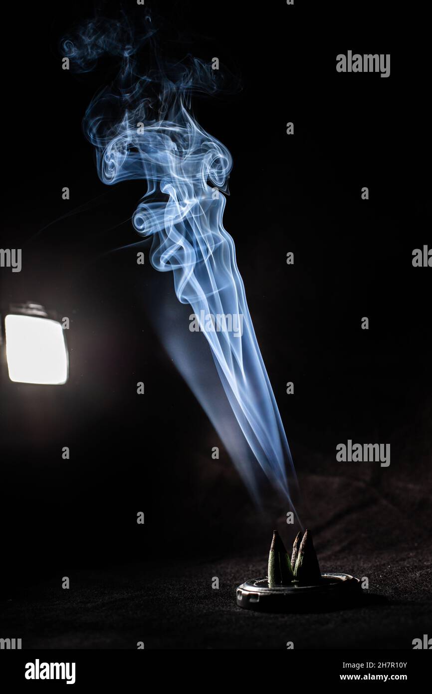 Smoke curves on a dark black background Stock Photo - Alamy