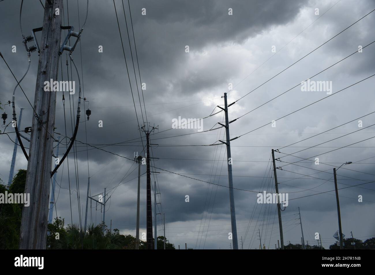 Multiple towers, poles and wires decorate the landscape on a cloudy day ...