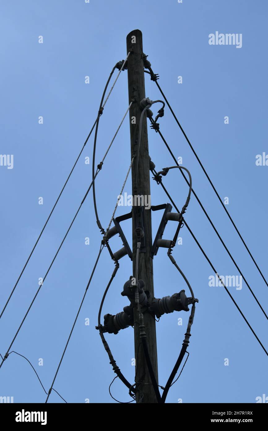Cables form an isosceles triangle over a utility pole Stock Photo - Alamy
