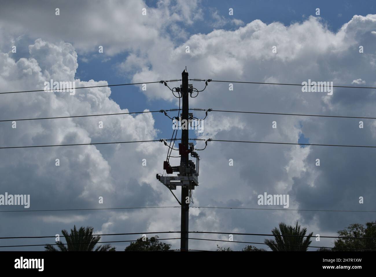Utility lines run parallel with cloud cover background Stock Photo - Alamy
