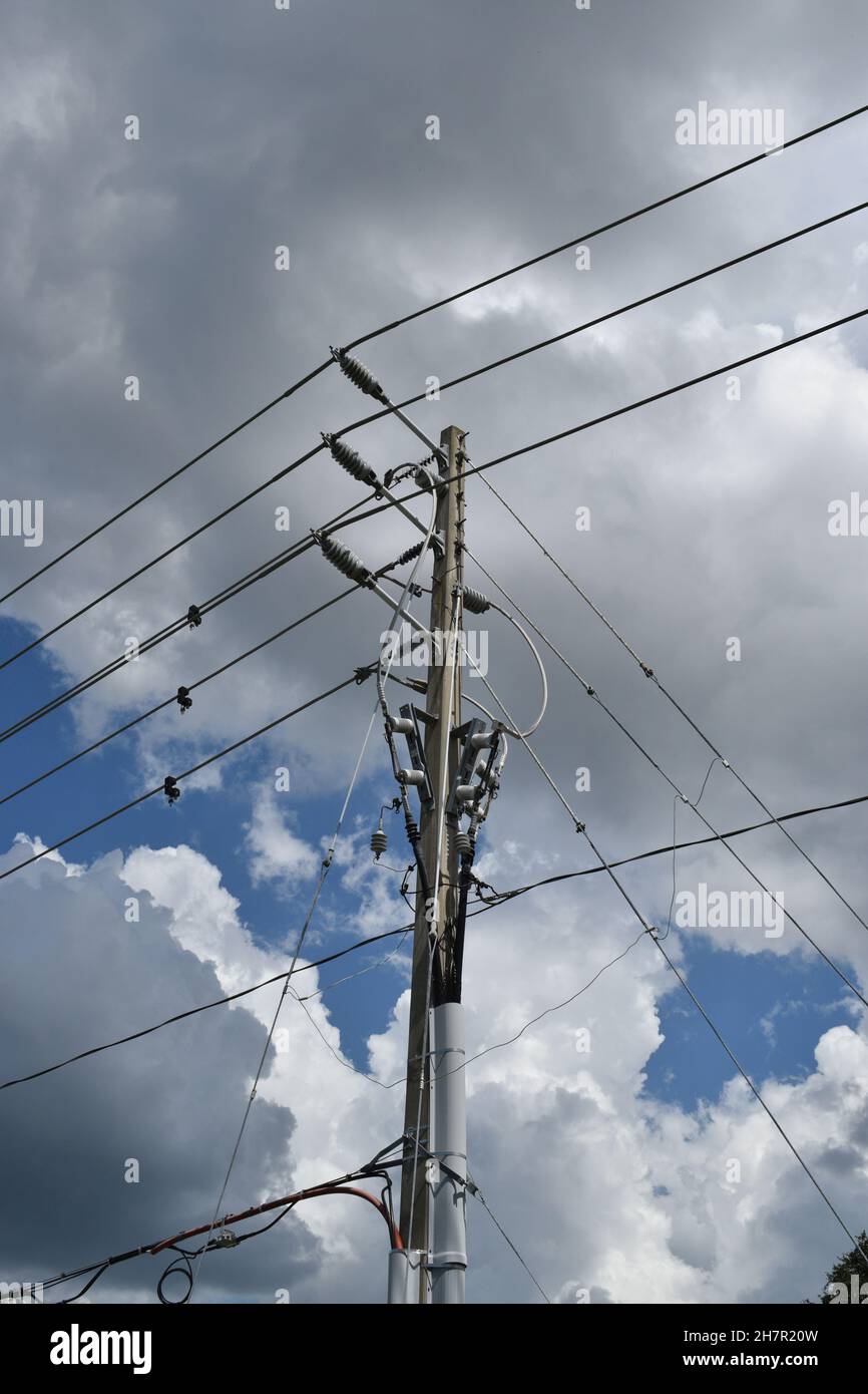 Power lines mix with other utility wires on a single pole Stock Photo ...