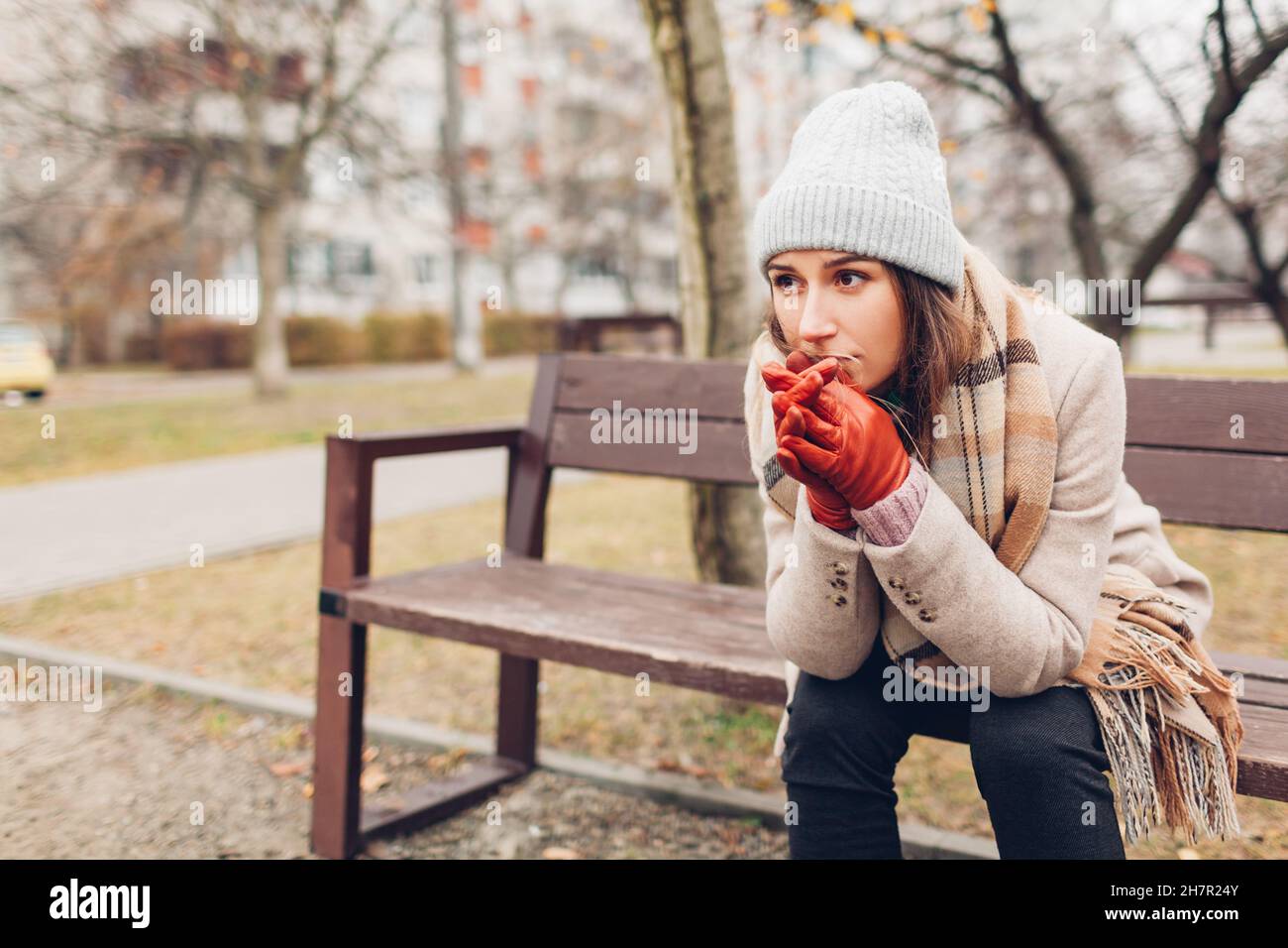 Depression. Sad woman in trouble sitting on bench in fall park alone ...
