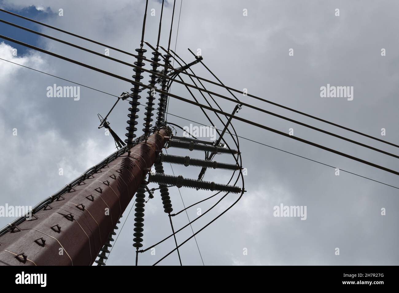 Close-up high power lines connected to a cell tower Stock Photo - Alamy