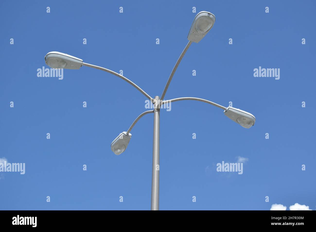 Four lights overhead on a single metal pole Stock Photo - Alamy