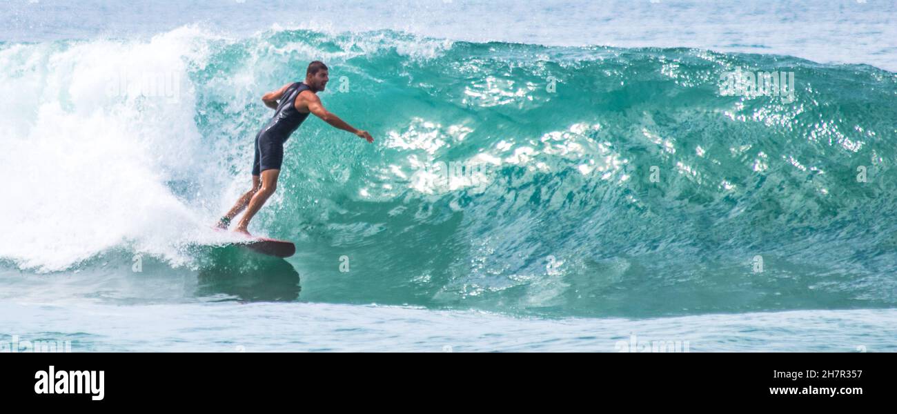 FLORIANOPOLIS, BRAZIL - Apr 01, 2019: A panoramic shot of a man surfing ...