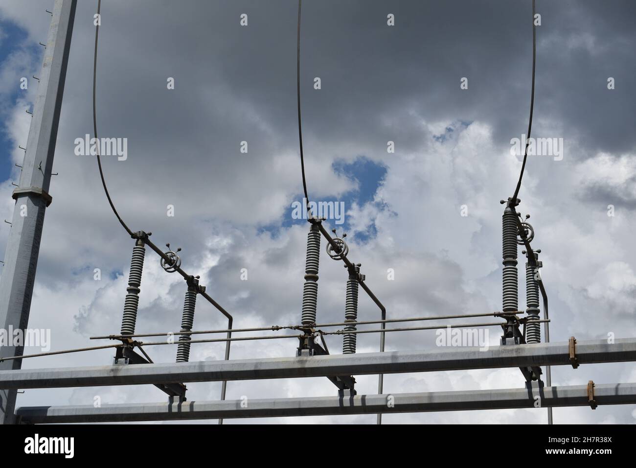 High voltage electrical connections on a cloudy day Stock Photo - Alamy
