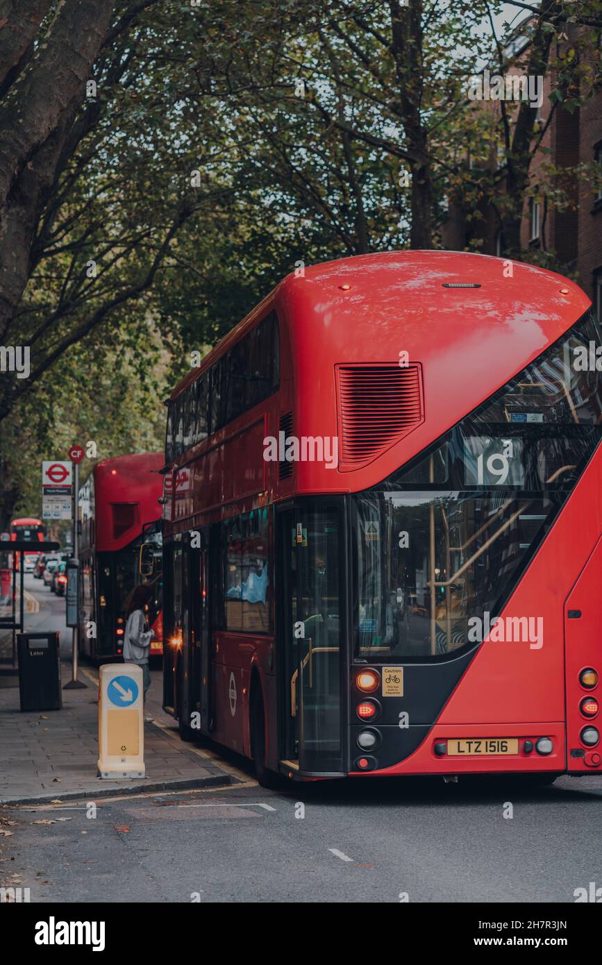 London, UK - October 23, 2021: Modern red double decker buses at a bus ...
