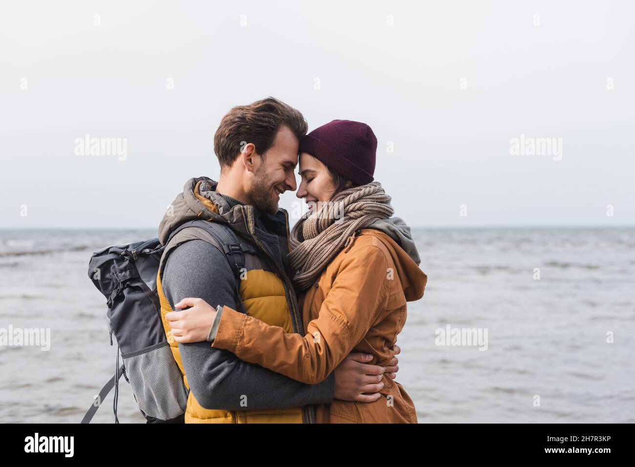 side view of couple embracing with closed eyes near sea Stock Photo - Alamy