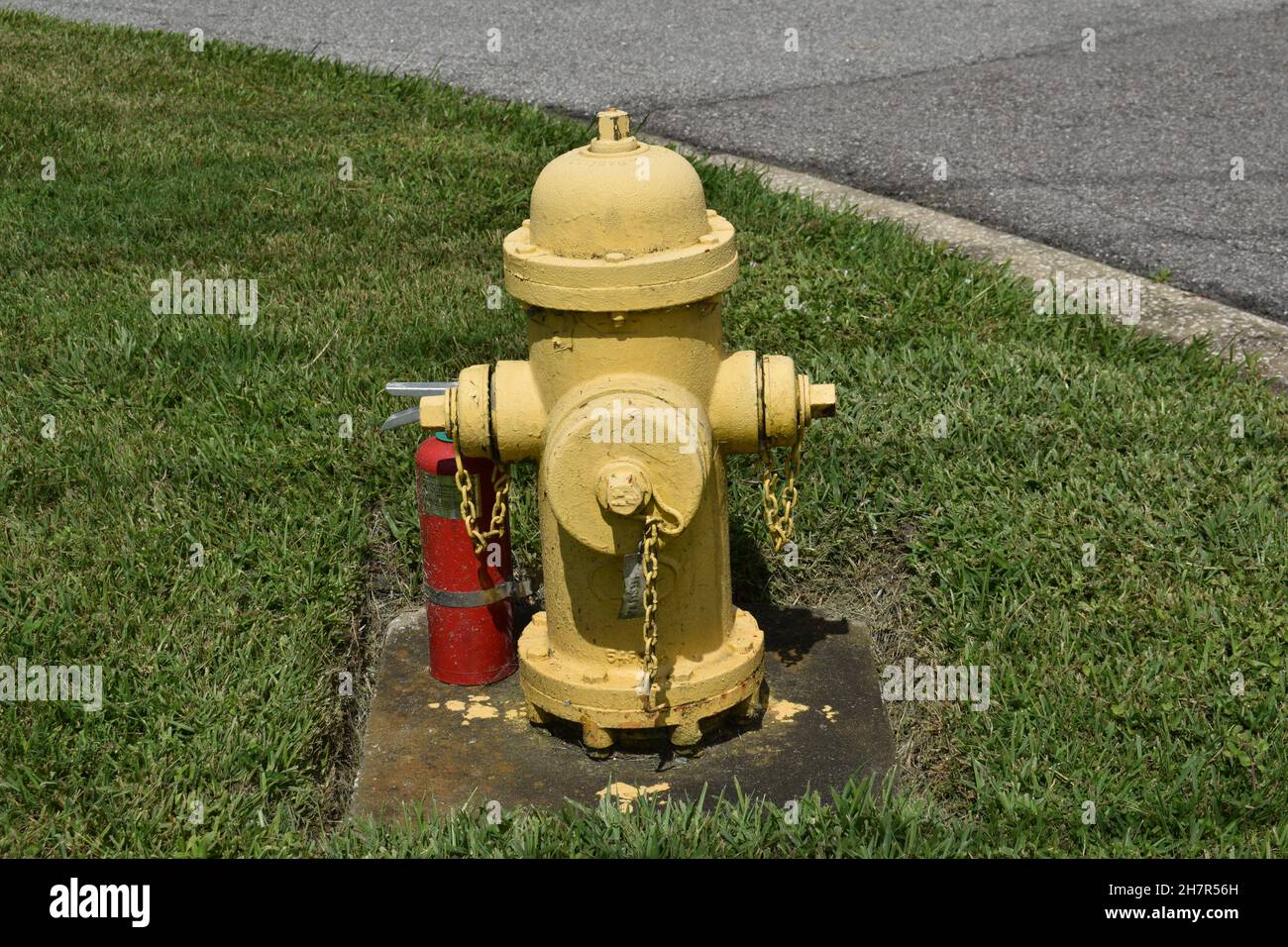 An old fire hydrant is near a portable extinguisher Stock Photo - Alamy