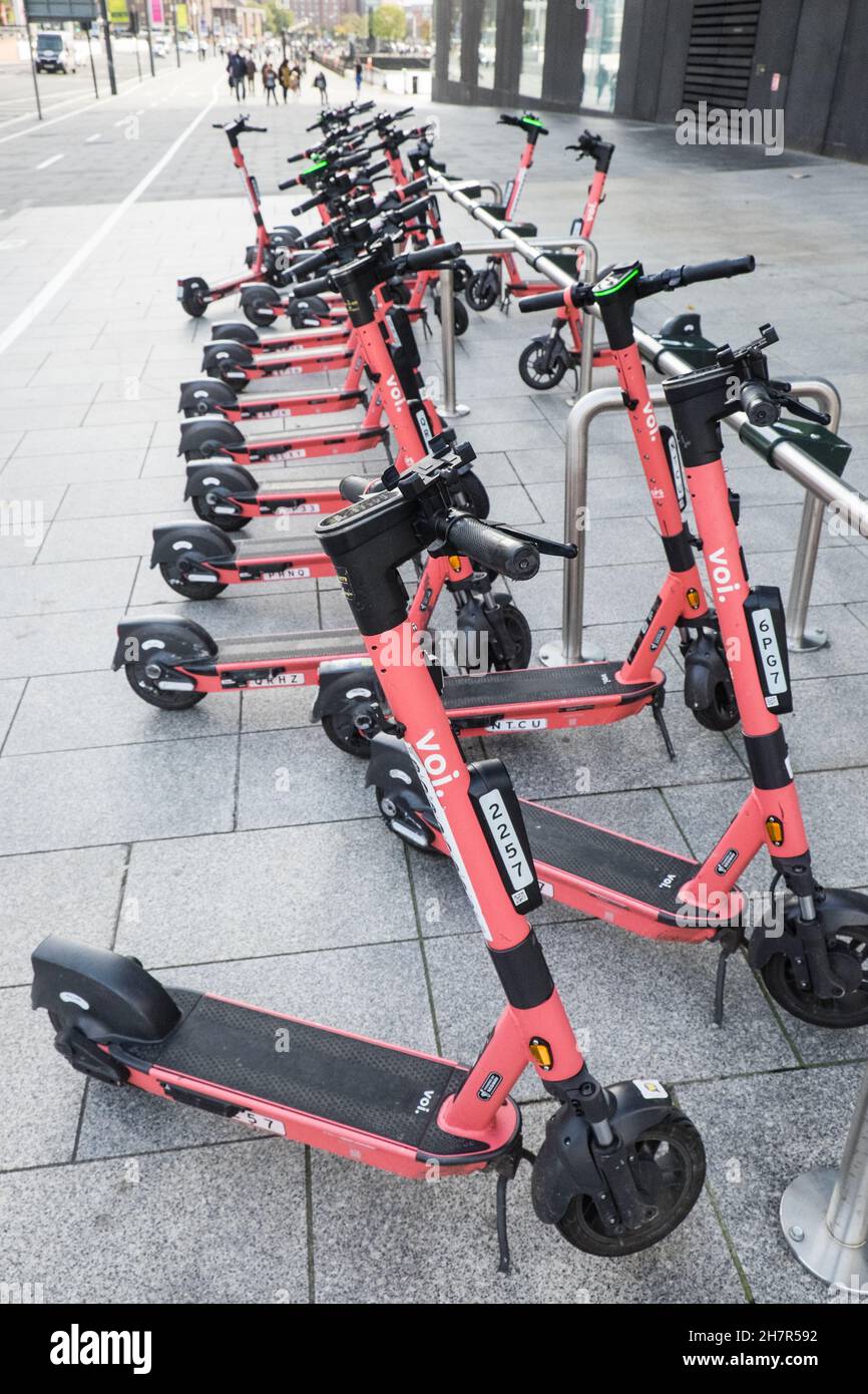 Electric scooters,pink,red,scooters,owned,by,Voie,company,on,the,street ...