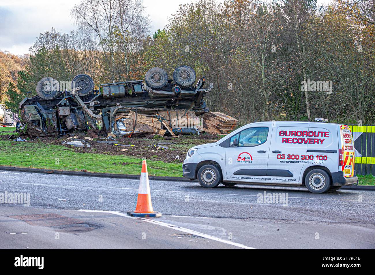 A surveyor's van is seen at the wreckage of the army heavy lifter truck ...
