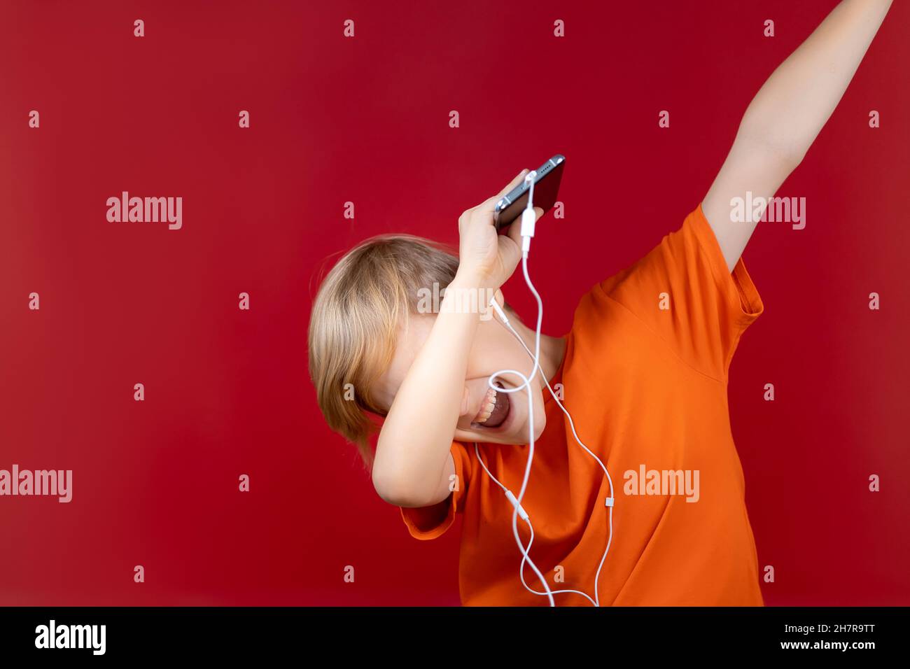 the boy with the phone in his hand covered his eyes with his elbows and ...