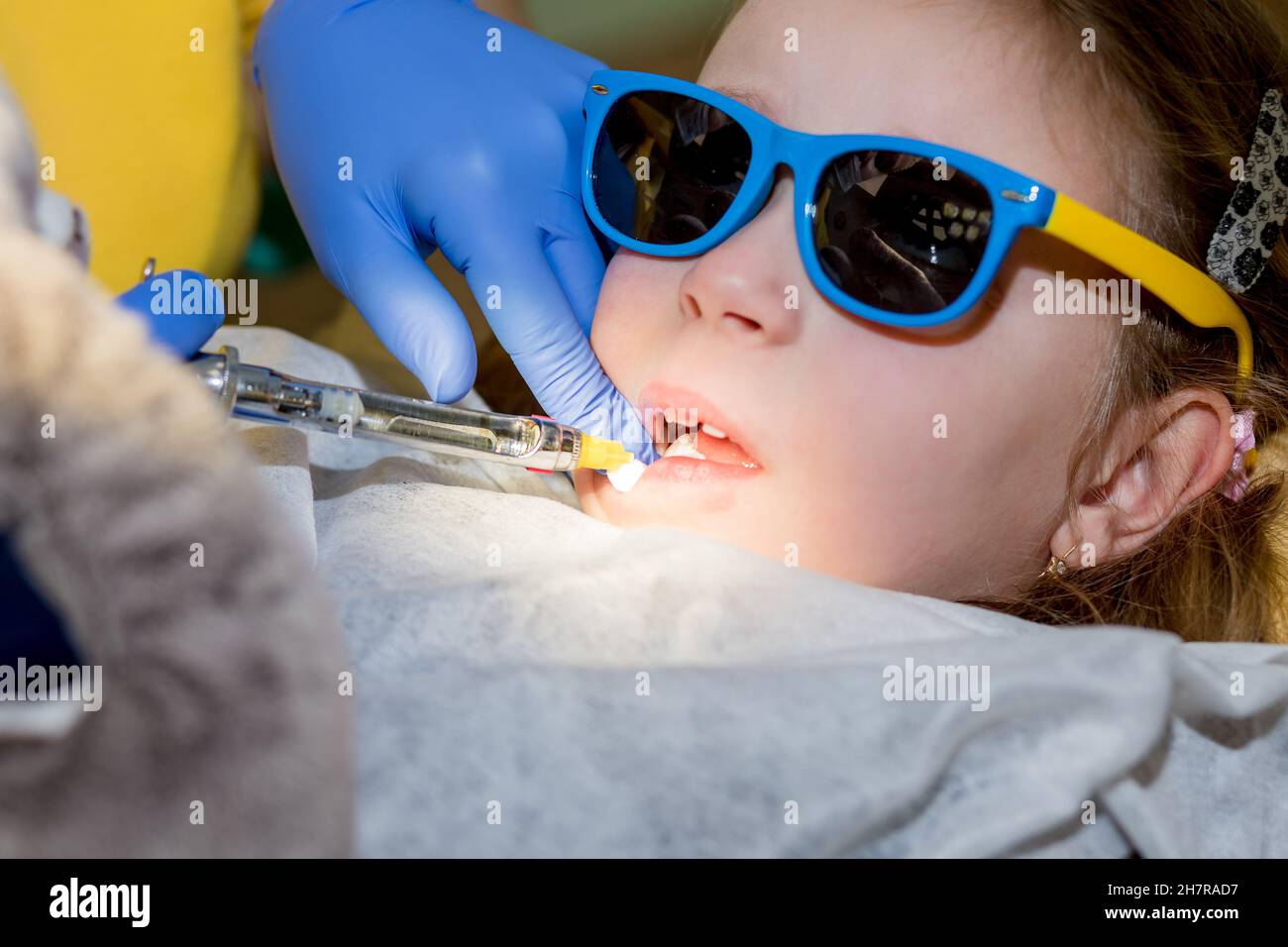 partial view of dentist giving injection on anesthesia to patient in ...