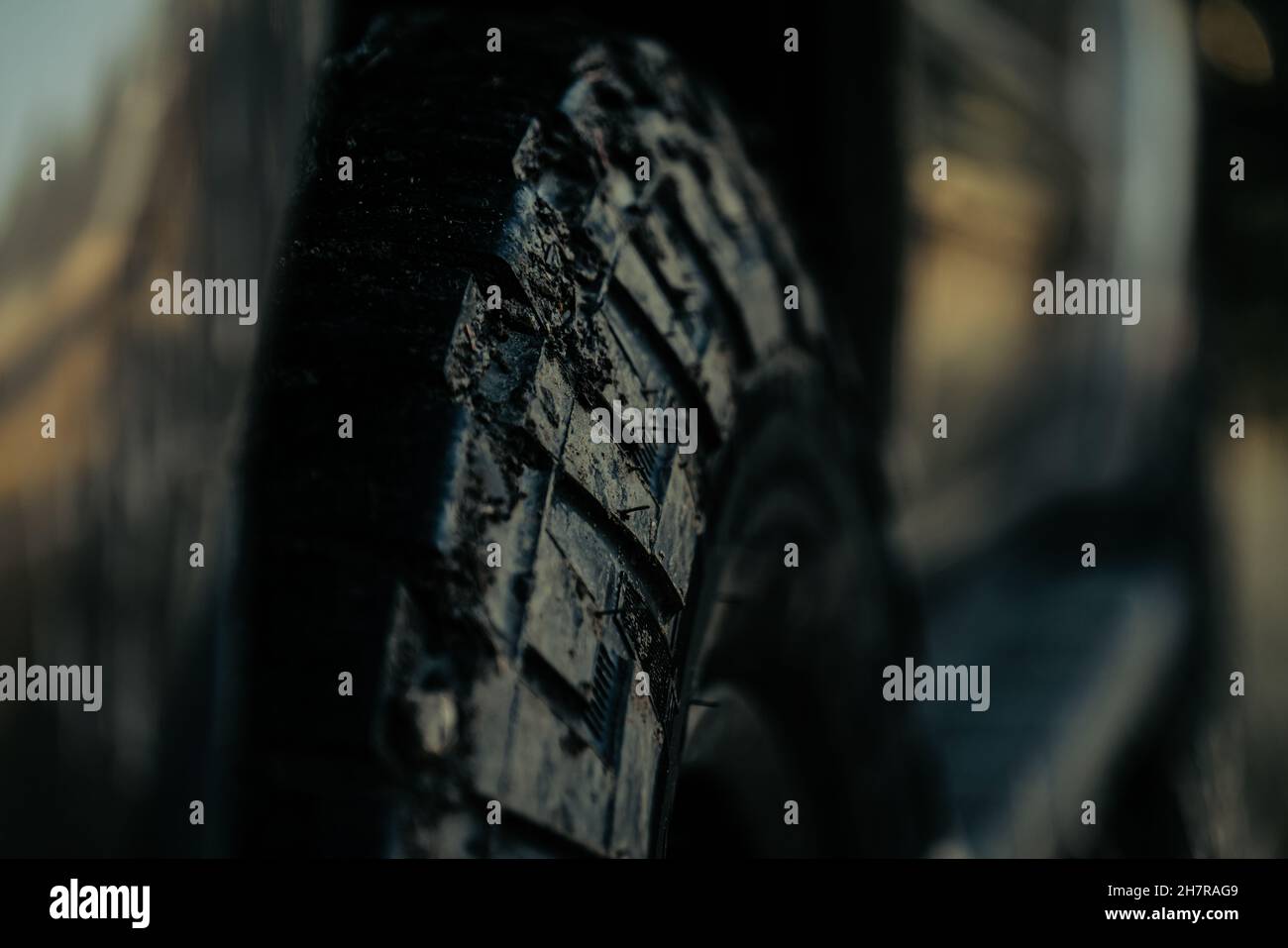 Close-up shot of all-terrain tires getting dirty after being on an off ...