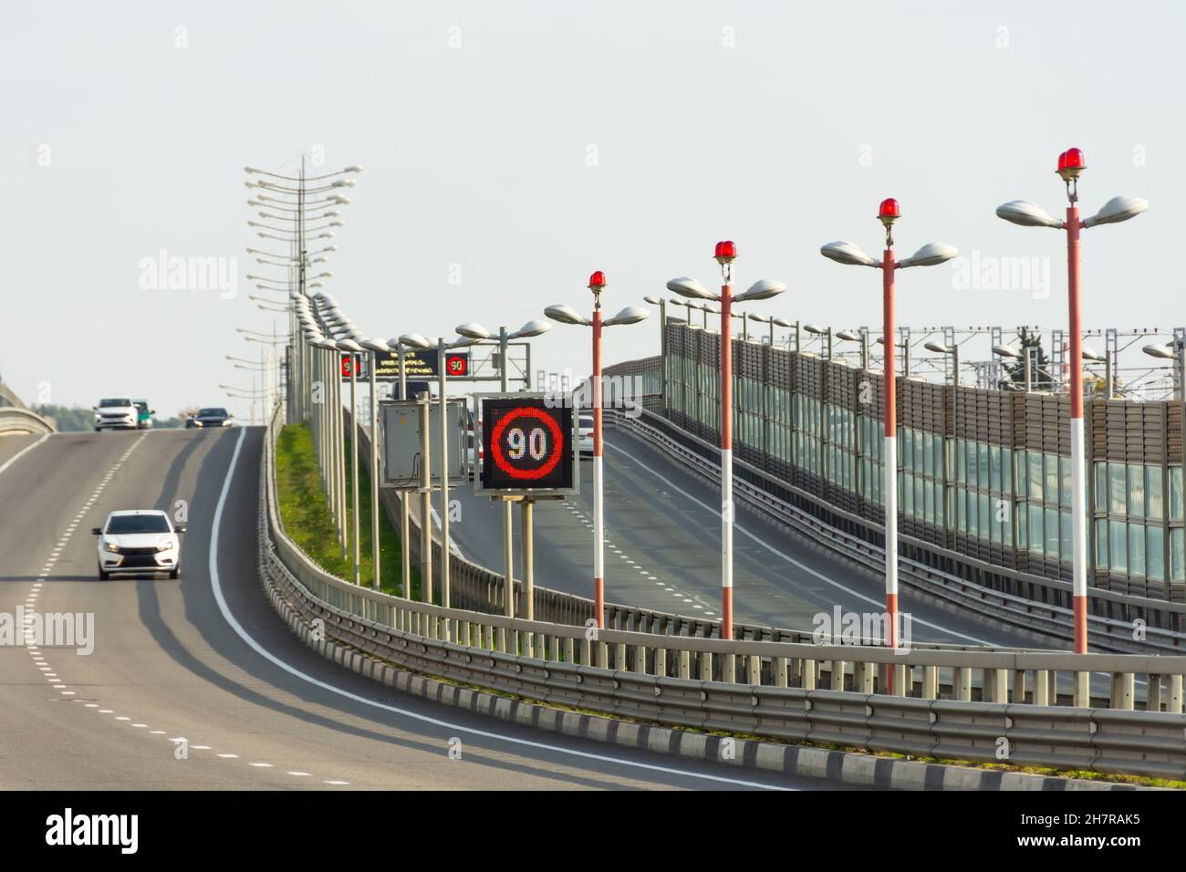 Expressway and ascent to the bridge with a speed limit sign under the ...