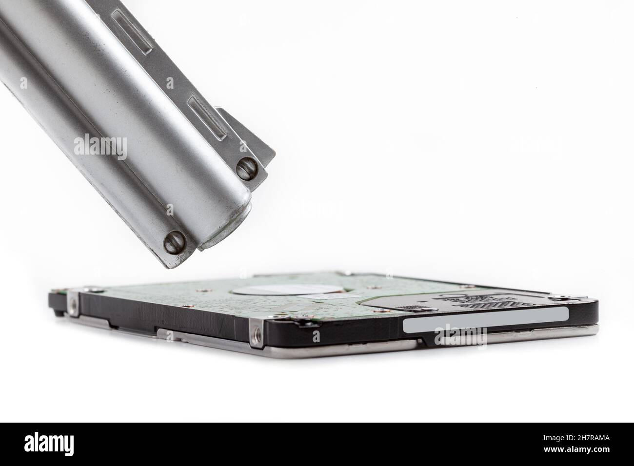 2.5 inch HDD hard drive and a gun barrel pointing towards it. Private ...