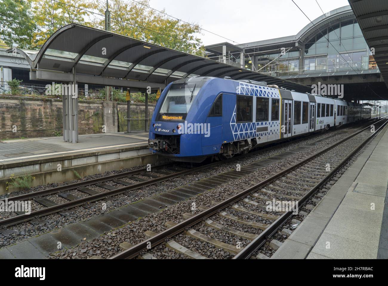 Modern train on the railway on the station Stock Photo - Alamy