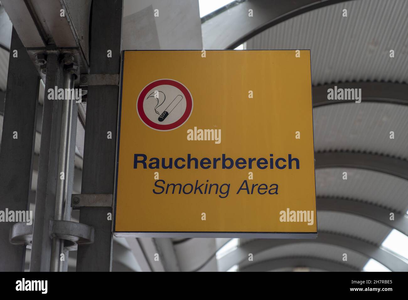 Yellow sign with information about the smoking area Stock Photo - Alamy