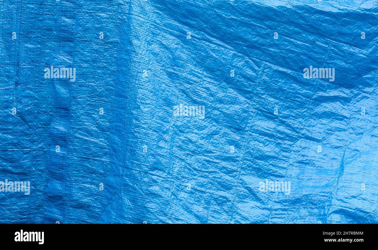 Simple blue plastic tarp, woven crumpled plain used protective ...