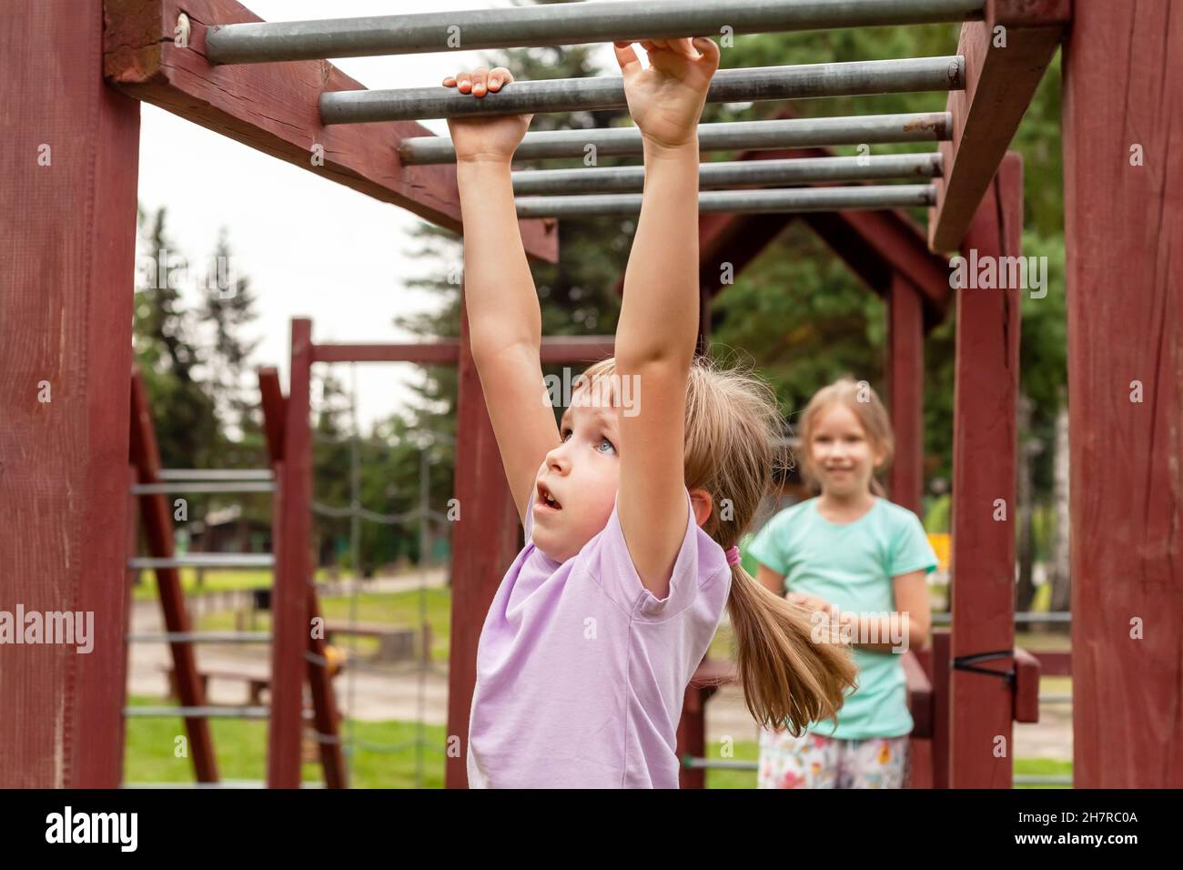 Elementary school age child exercising, climbing, playing on the ...