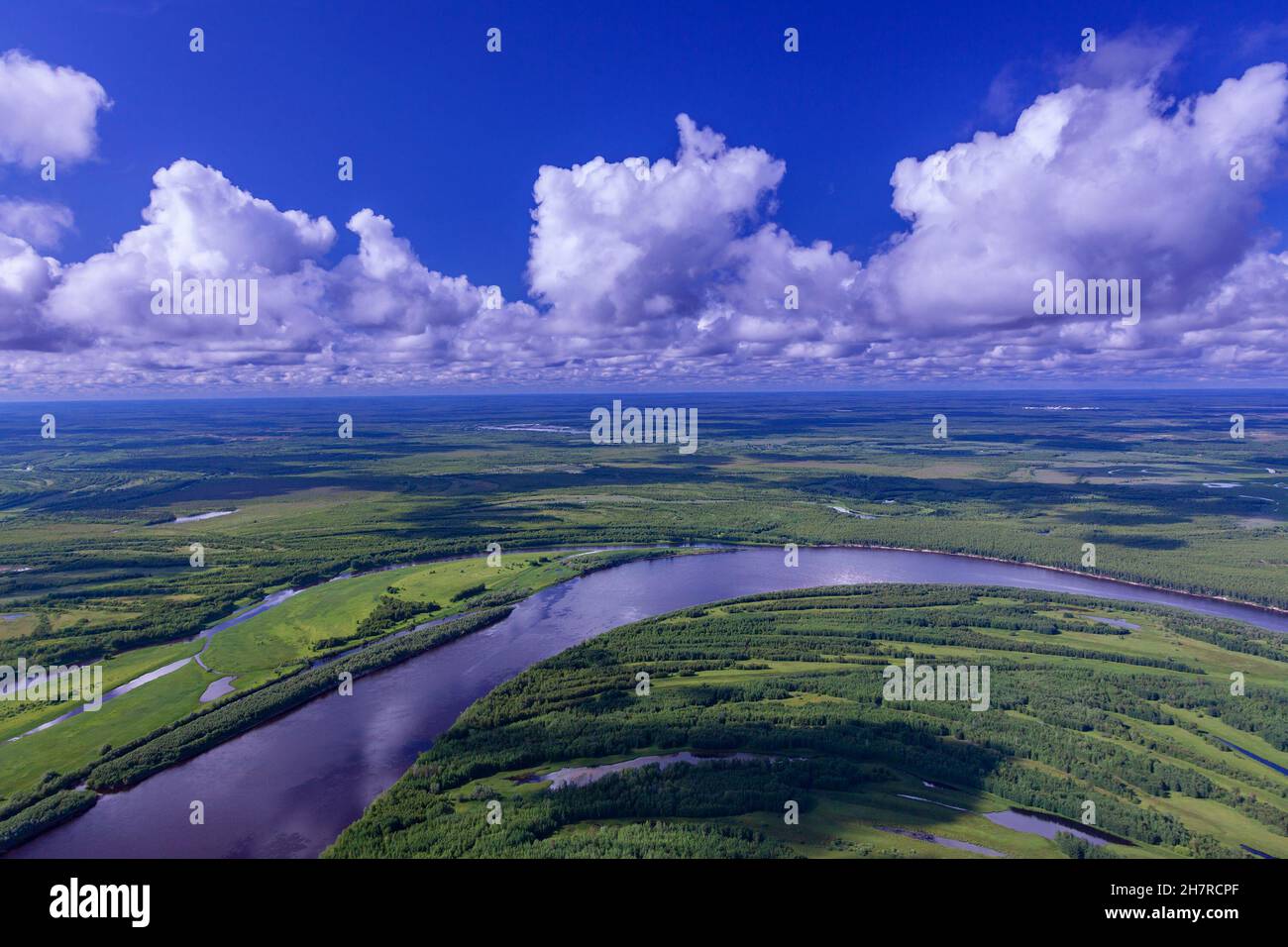 Aerial view of forest river over the endless woodlands during a summer ...