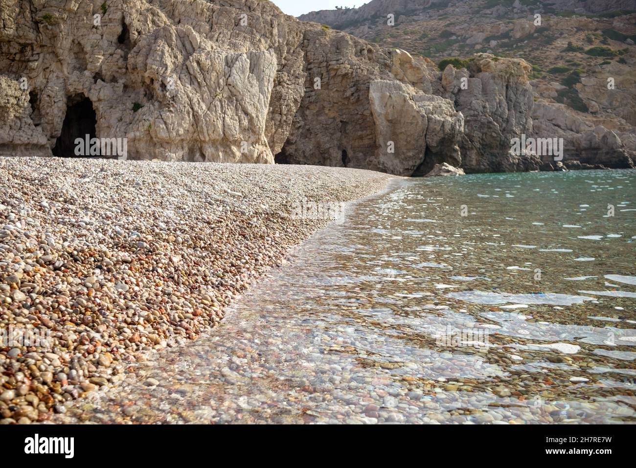 Photo from famous rocky beach of Traganou with iconic caves, Rhodes ...