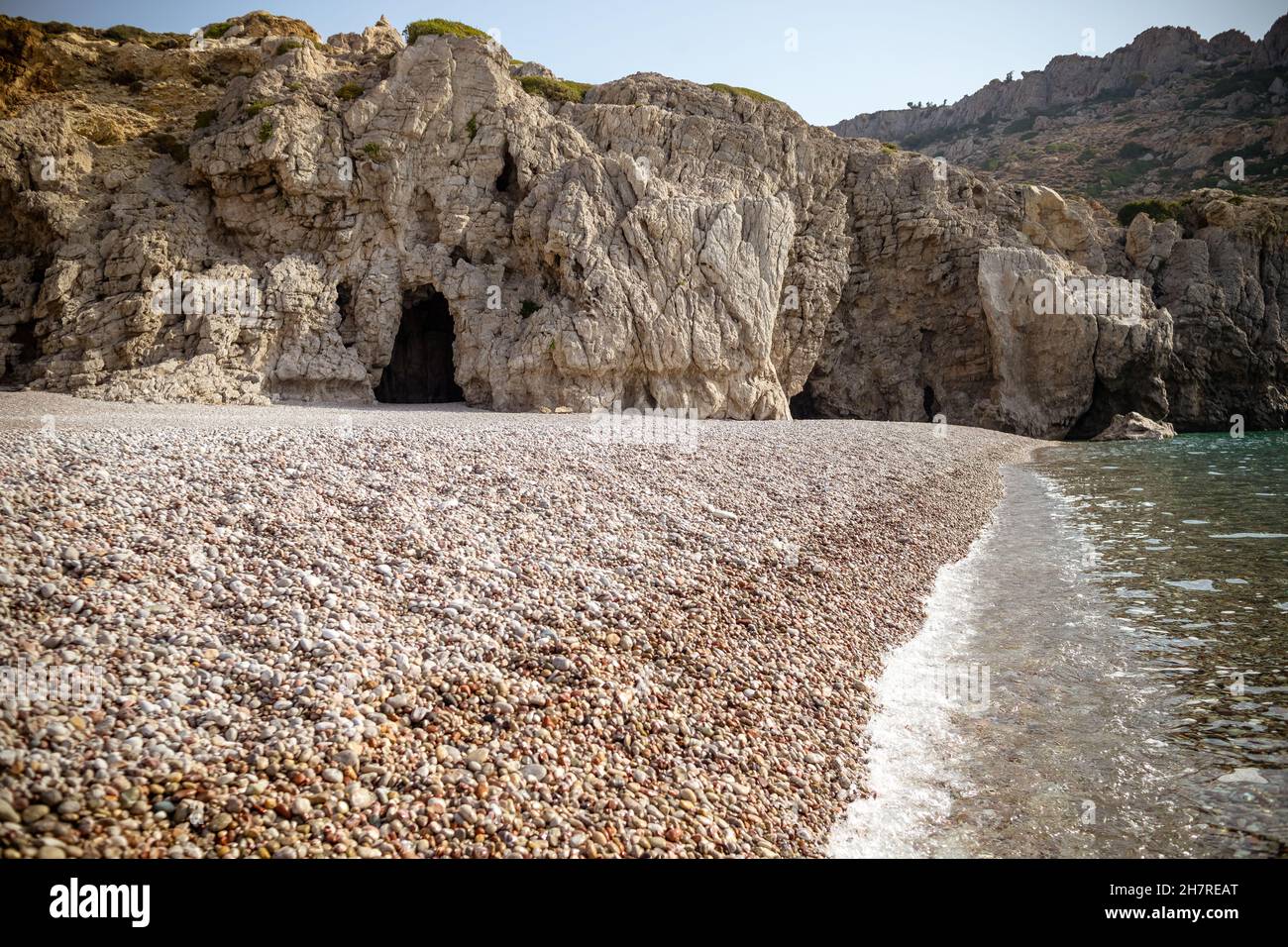 Photo from famous rocky beach of Traganou with iconic caves, Rhodes ...