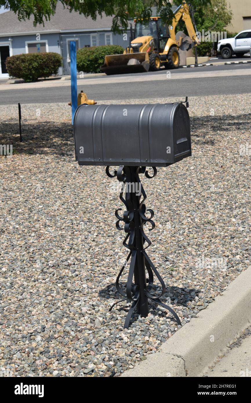 Angle view of standard black metal mailbox on wrought iron stand Stock ...