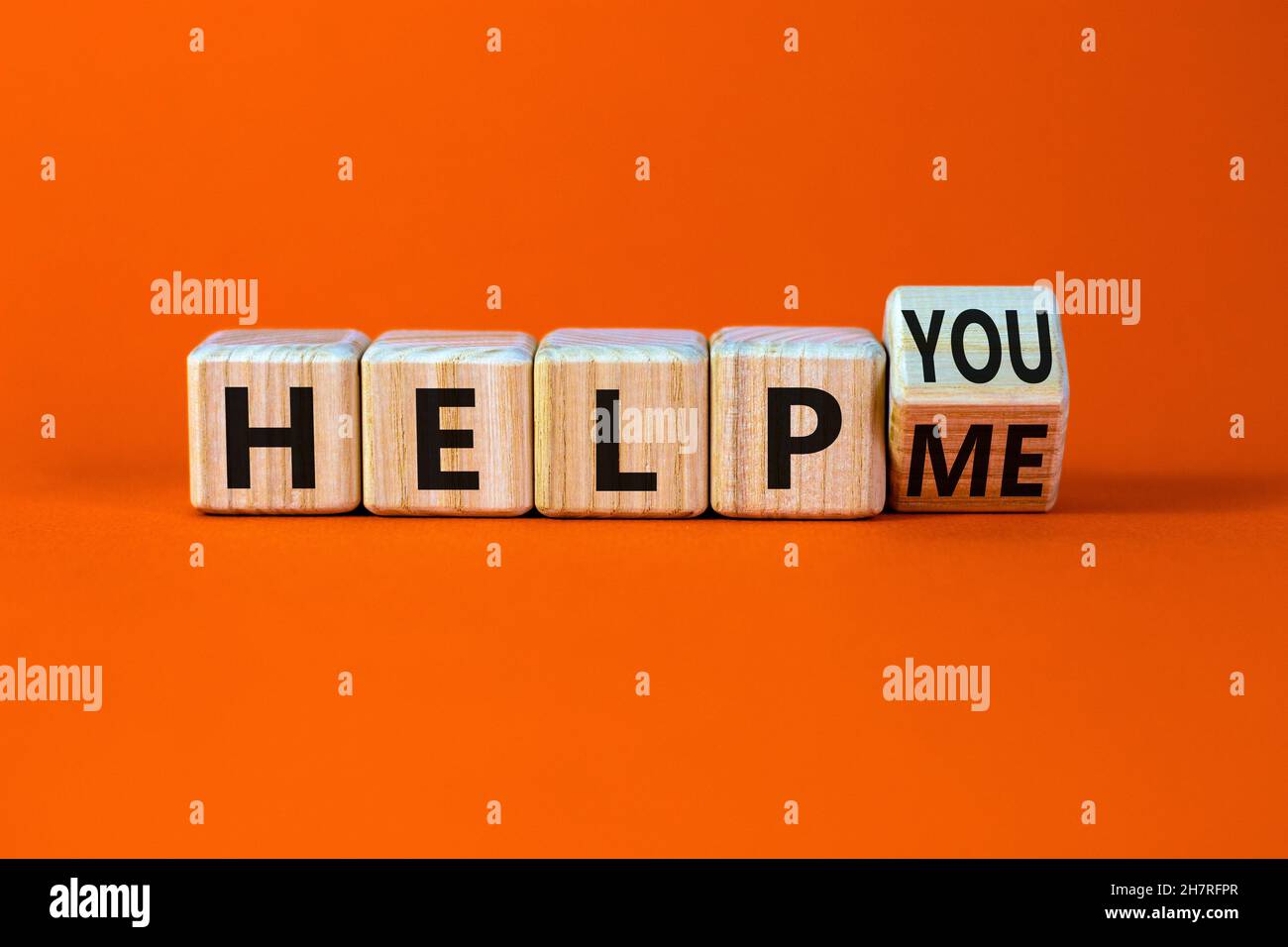 Help you or me symbol. Turned a wooden cube and changed words help me ...