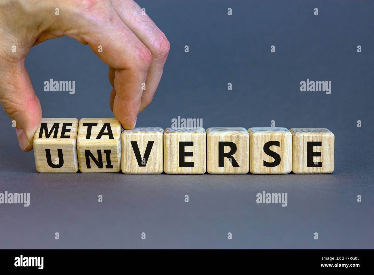 Universe or metaverse symbol. Businessman turns wooden cubes and ...