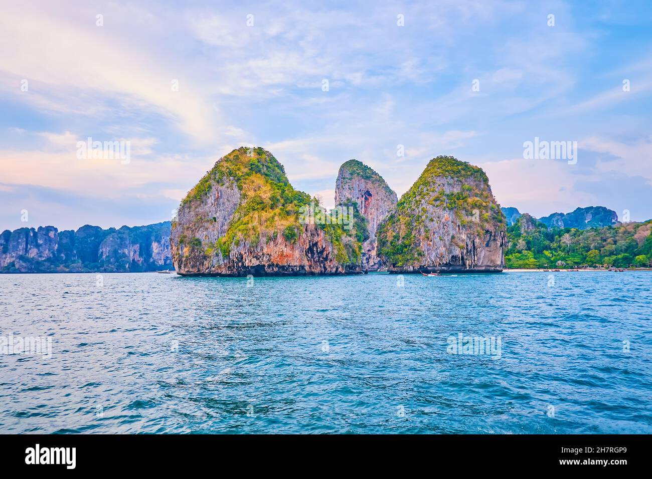 Yacht trip along Railay Peninsula rocky coast with a view on tiny Ko ...