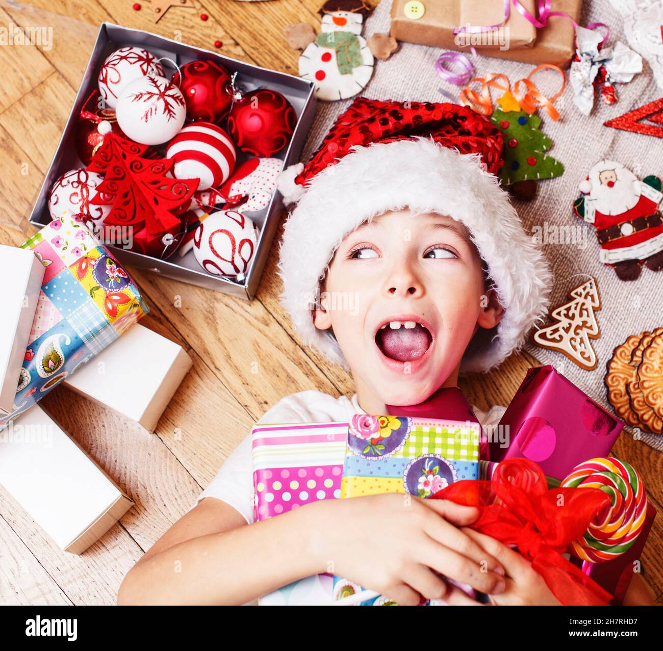 little cute boy with Christmas gifts at home. close up emotional happy ...