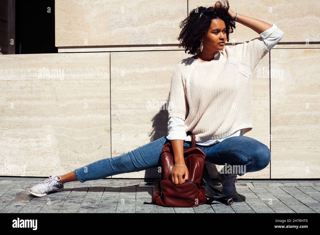 young pretty african girl posing cheerful on city background, lifestyle ...