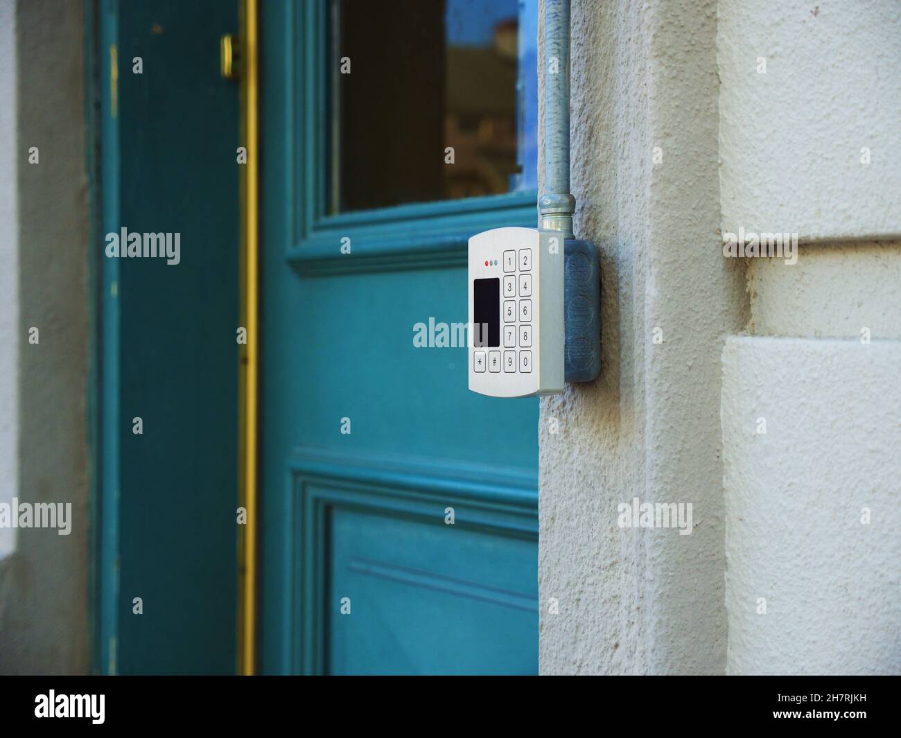Closeup of an intercom installed on the wall at the building entrance ...