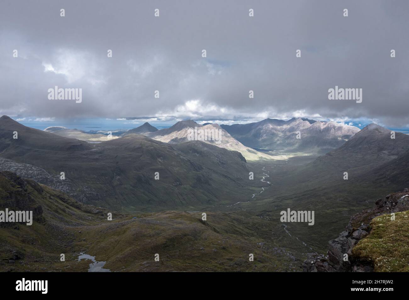 Majestic mountain ridge and valley with drifting clouds and rock and ...