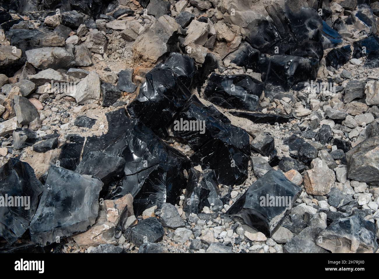 Black obsidian glass rocks in Newberry caldera in Oregon Stock Photo - Alamy