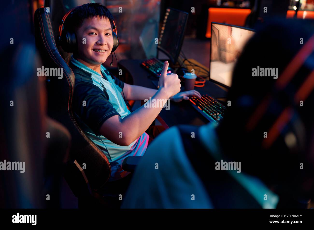 Professional gamer participates in team play in cyber club Stock Photo ...