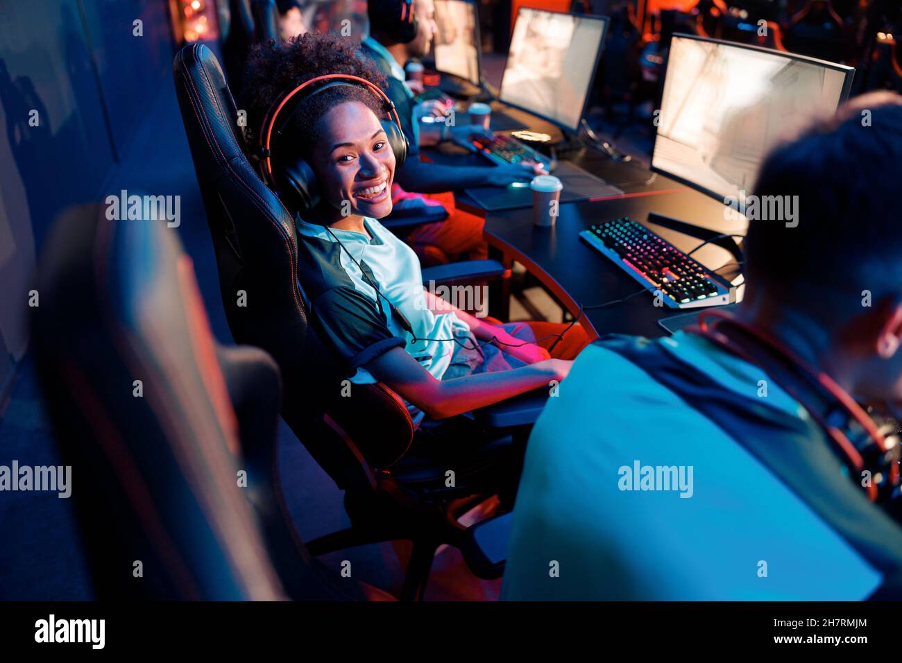 Female gamer sitting on gaming chair in computer club Stock Photo - Alamy
