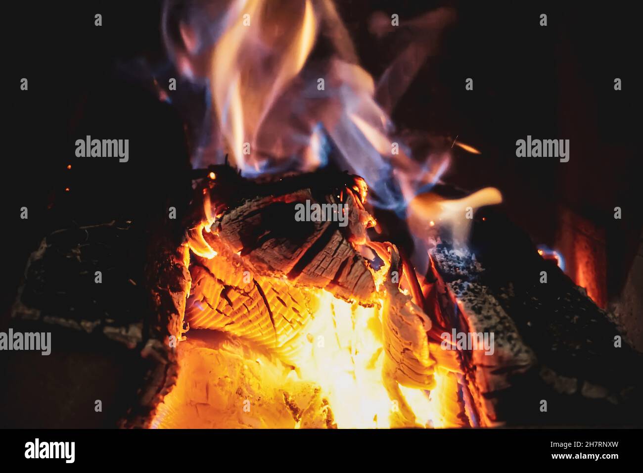 Fire burning glowing in rustic wood burning cast iron stove, log burner ...