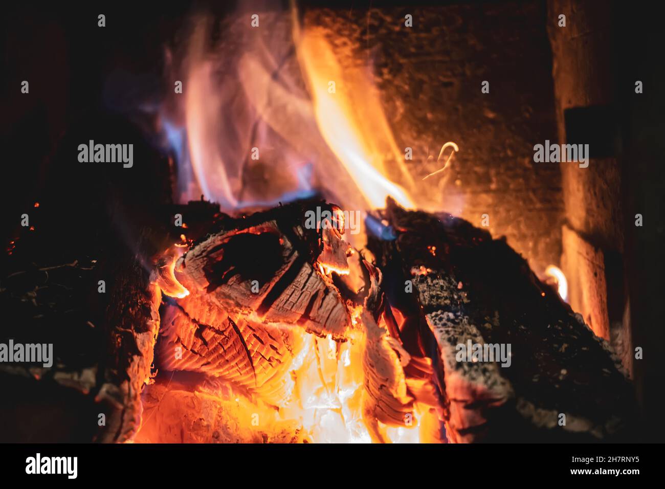 Fire burning glowing in rustic wood burning cast iron stove, log burner ...