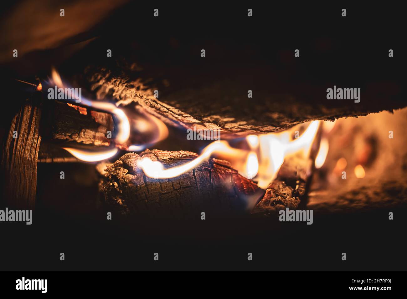 Fire burning glowing in rustic wood burning cast iron stove, log burner ...