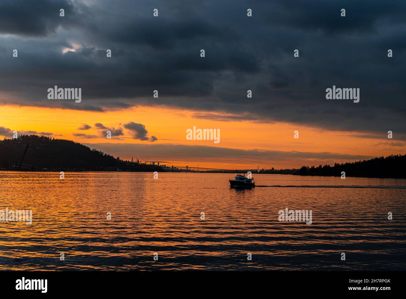 Beautiful orange sunset sky reflected on the tranquil water and a ship ...