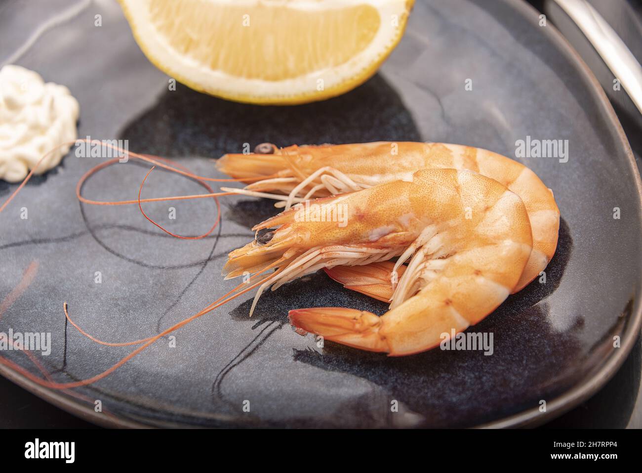 Roasted tails of shrimps with fresh rosemary and lemon Stock Photo - Alamy