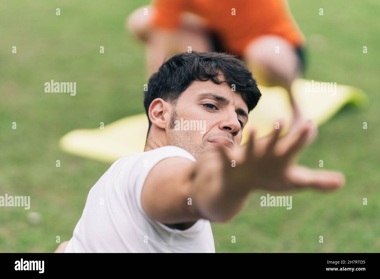 Focus on the face of a man stretching while doing yoga outdoors Stock ...