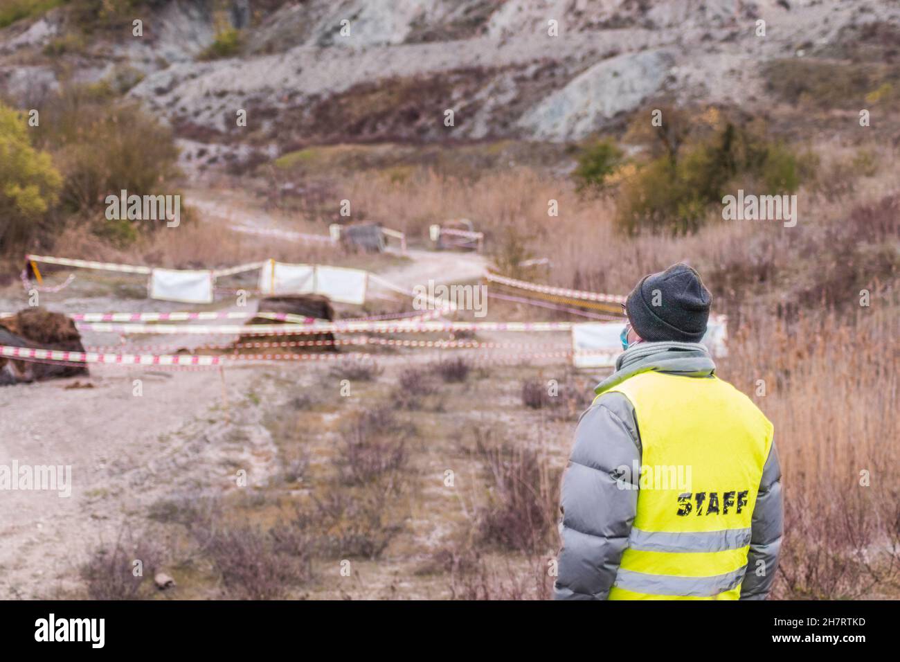 Back view of a race official staring at the circuit during a rally ...