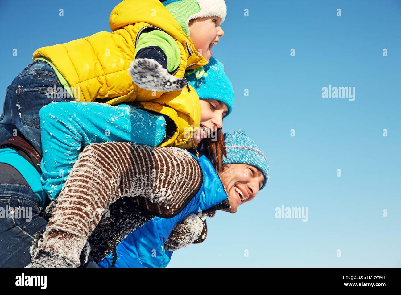 portrait of a happy family in the winter. parents and child outdoors ...